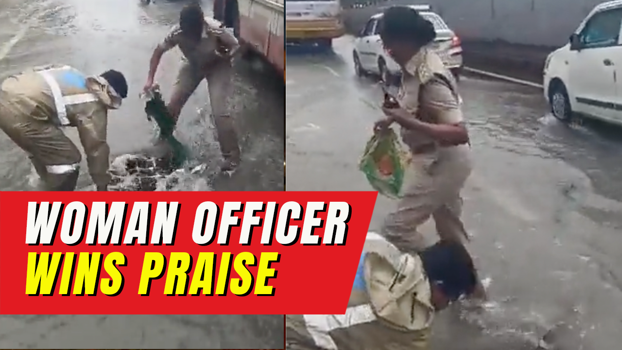 Watch: Woman police officer cleans drain outlet by hand to allow ...