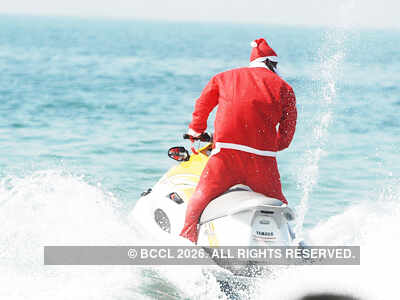A man dressed as Santa Claus enjoys a jet ski at Baga beach