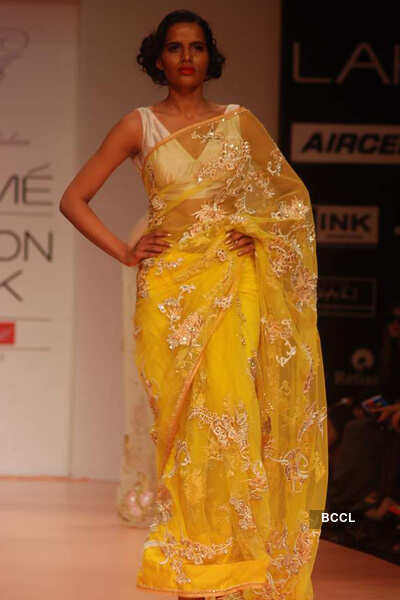 A model walks the ramp to showcase a creation by designer Bhairavi ...