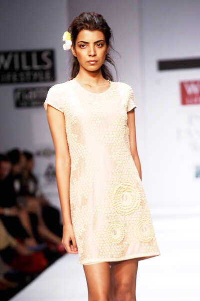 A model displays a creation by designer Manish Gupta on Day 3 of Wills ...