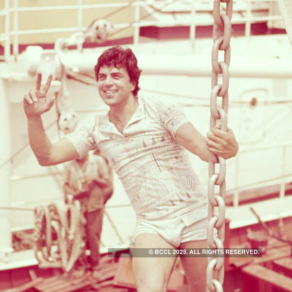 Handsome hunk Dharmendra flashes victory sign in body hugging T-shirt and white shorts during ...