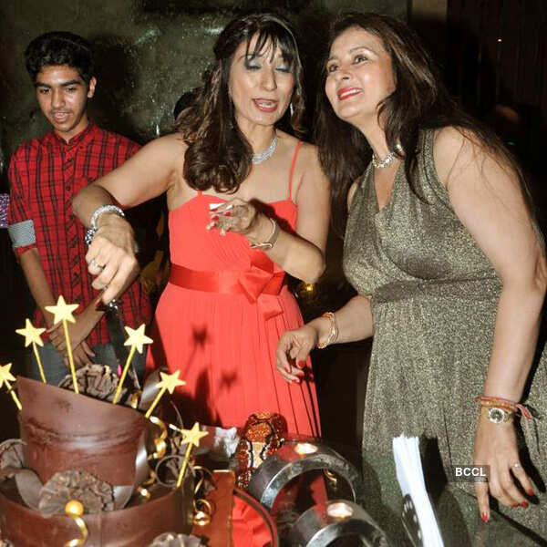 Dr.Rishma Pai cuts the cake in presence of sister Poonam Dhillon during ...