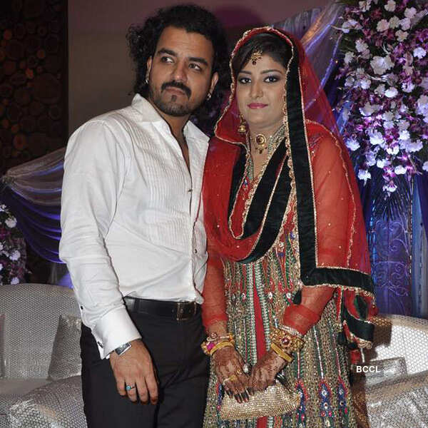Newlyweds Toshi Rana and Amna Ali pose on stage during their wedding ...