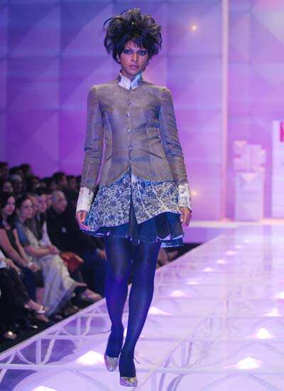 Nina Manuel displays an outfit from designers Anamika Khanna and Ashish ...