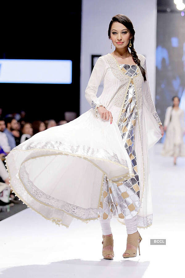 A Pakistani model presents a creation by designer Nida Azwer during the ...