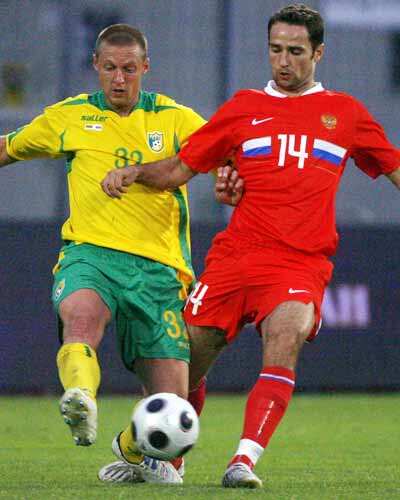 Russian defender Roman Shirokov (R) vies with Lithuanian Robertas ...