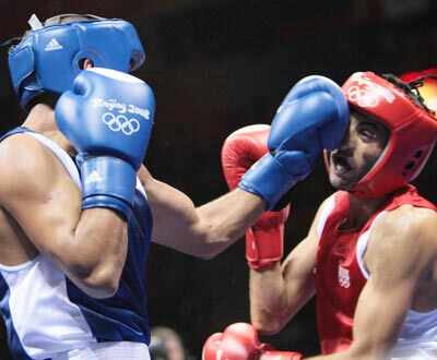 Akhil Kumar of India celebrates his victory over Ali Hallab of France ...