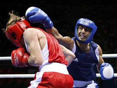 Akhil Kumar of India celebrates his victory over Ali Hallab of France ...