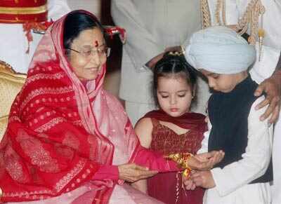 President Pratibha Devi Singh Patil blessing a boy on the occasion of ...