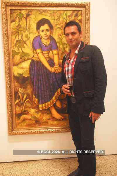 A guest at artist Shankar Devrukhe's painting exhibition held at ...