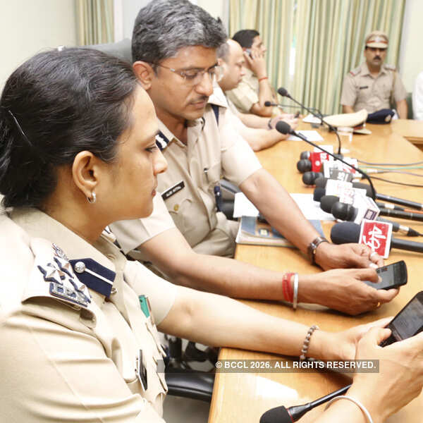 Gurgaon Police personnel checking the app on their mobiles.