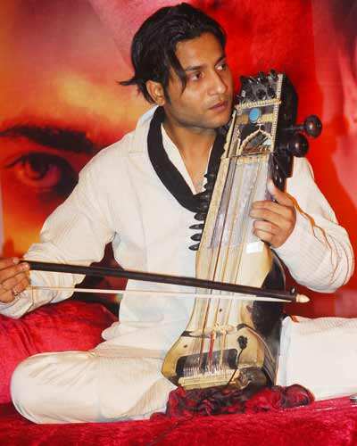 A musician performs during the 'Gulaal' Holi party celebrated at the ...