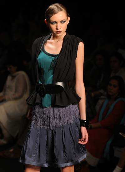 A model presents a creation by designers Gunjan and Rahul during the ...