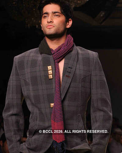 Cricketer Murli Karthik presents a creation by designer Manish Malhotra ...