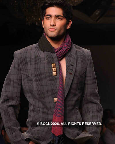 Cricketer Murli Karthik presents a creation by designer Manish Malhotra ...