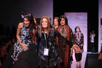 Chitrangada Singh and designer Reynu Taandon walk the ramp after their ...