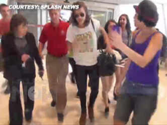 One Direction's Harry Styles mobbed by fans at airport