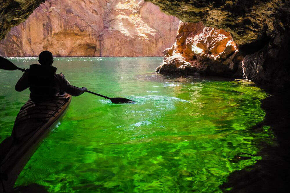 Kayak over emerald-colored water, Nevada - TimesTravel