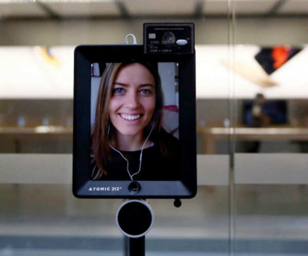 Lucy an Atomic 212 Robot with an image of owner on Facetime stands ...