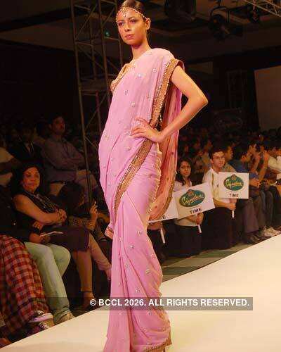 Sapna Kumar displays a creation by designer Rocky S during the Day 1 of ...