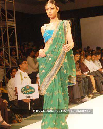 Sapna Kumar displays a creation by designer Rocky S during the Day 1 of ...