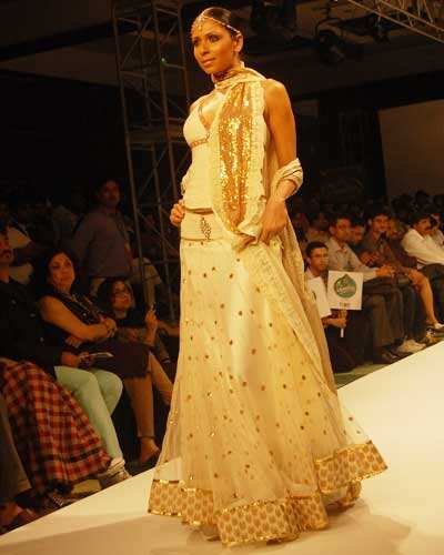 Sapna Kumar displays a creation by designer Rocky S during the Day 1 of ...