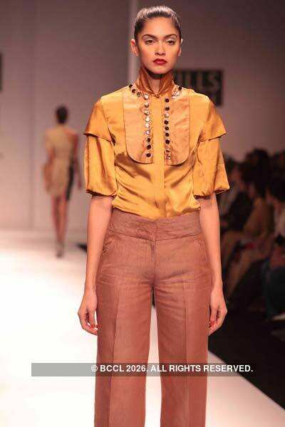 A model presents a creation by designer Narendra Kumar on Day 1 of ...