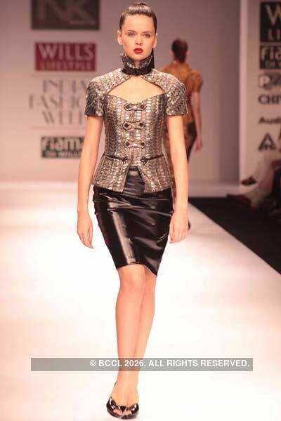 A model presents a creation by designer Narendra Kumar on Day 1 of ...