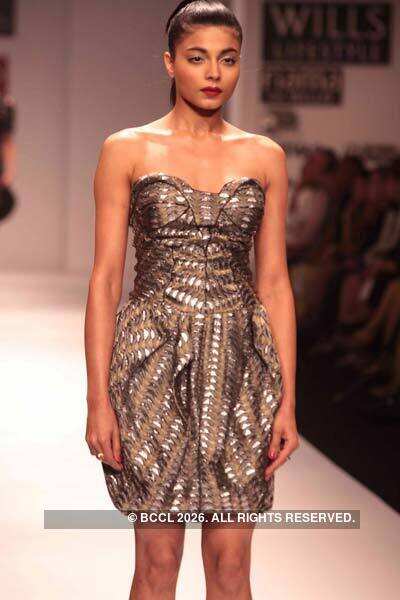 A model presents a creation by designer Narendra Kumar on Day 1 of ...