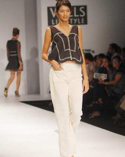 Lisa Haydon presents a creation by designer Rahul Mishra on Day 1 of ...
