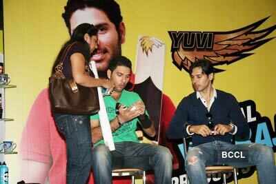 Yuvraj Singh with a young fan at the launch of his official merchandise ...