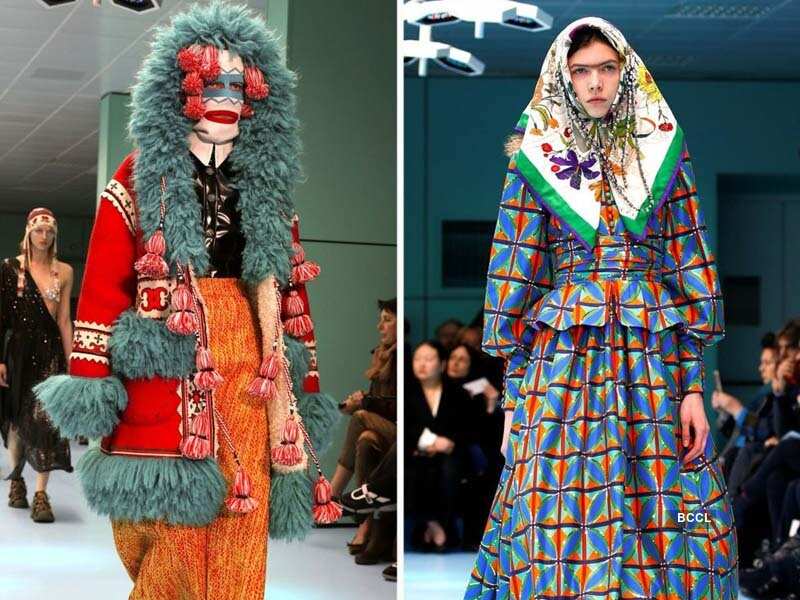 Models carry fake heads on the ramp