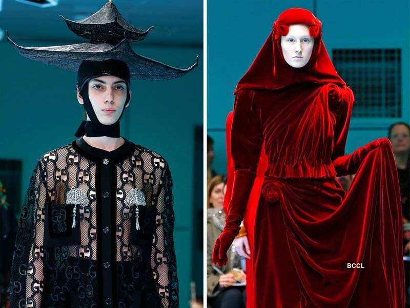 Models carry fake heads on the ramp