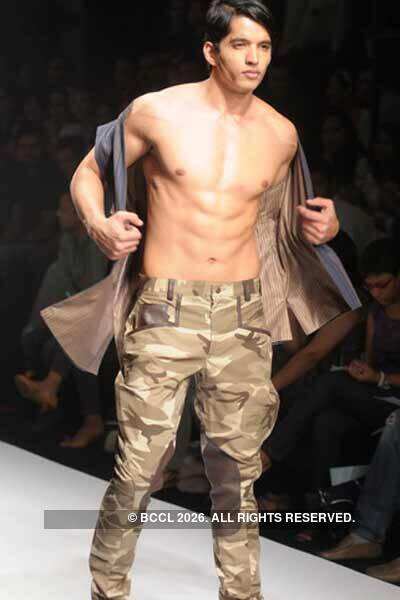 A model presents a creation by designer Vijay Arora on the Day 2 of the ...