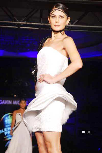 Alecia displays a creation by designer Gavin Miguel on day 2 of ...