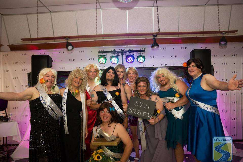 Men participate in a pageant dressed as women