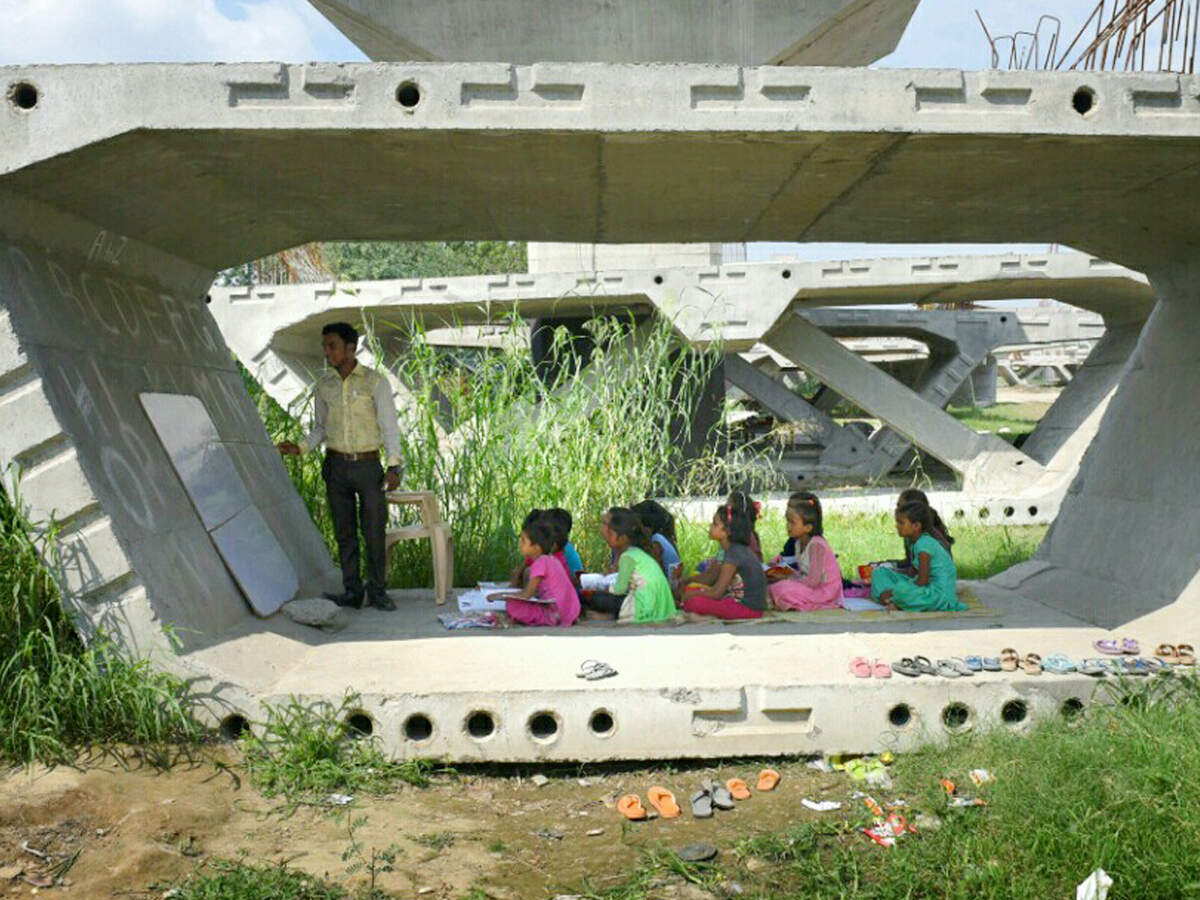 This guru teaches slum children under concrete slab near Yamuna Bank