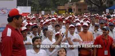 An elderly woman on a wheel chair participates in a walk to create ...