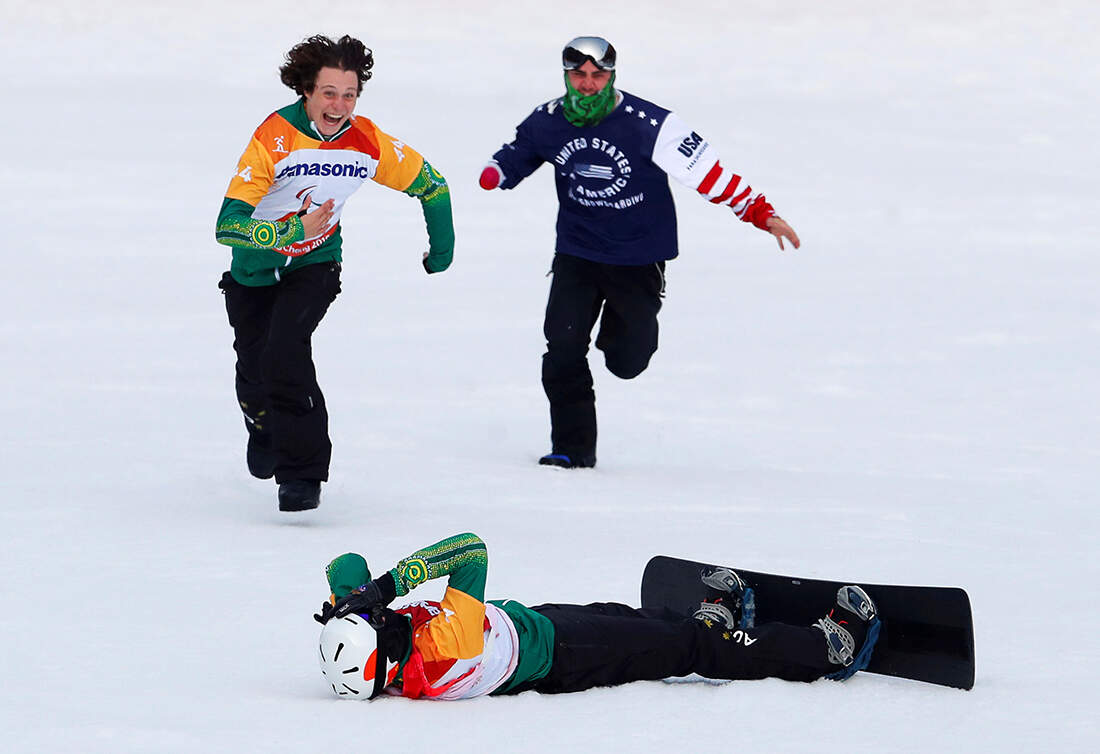 Simon Patmore of Australia lies in the snow after winning the event as ...