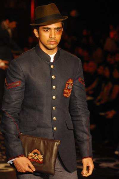 A model walks the ramp to showcase a creation by designer Arjun Khanna ...