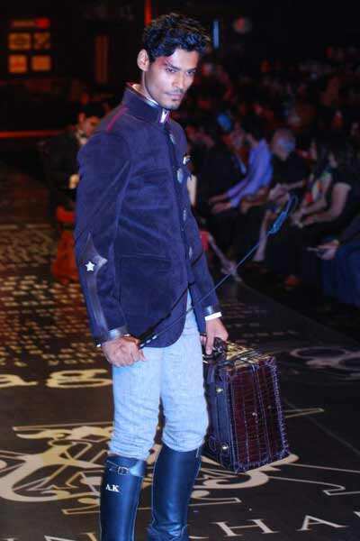 A model walks the ramp to showcase a creation by designer Arjun Khanna ...