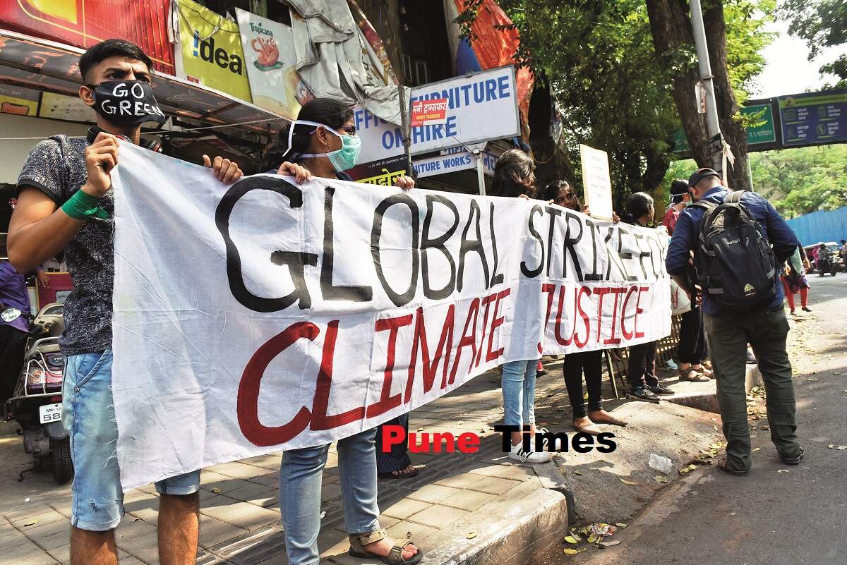 Songs, placards and a human chain – climate crisis protest grabs the ...