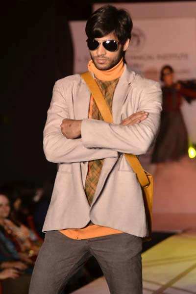 A model showcases a creaton during LS Raheja College's fashion show at ...