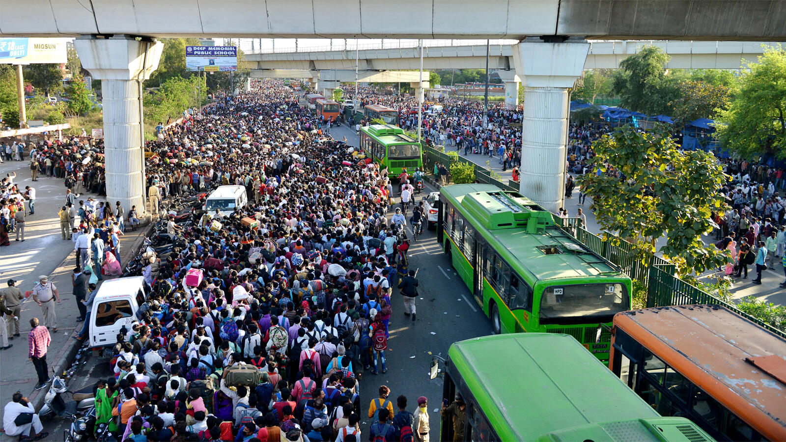 Watch: Thousands of migrant workers crowd Anand Vihar Bus Terminal amid ...