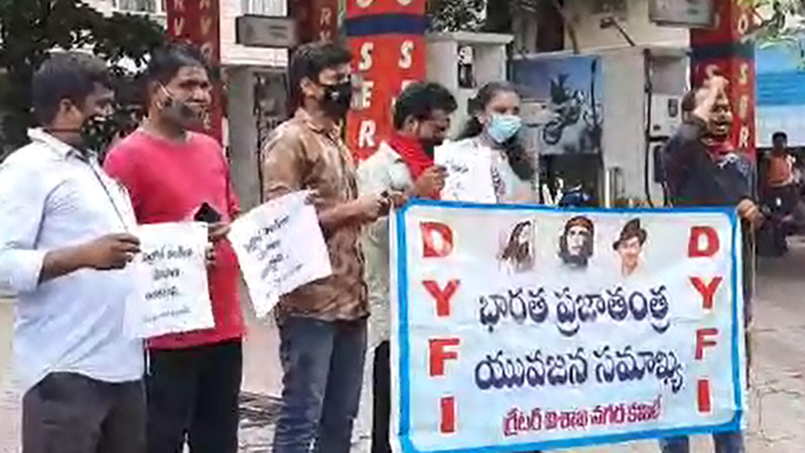 Members of DYFI stage protest in front of petrol outlet in Visakhapatnam