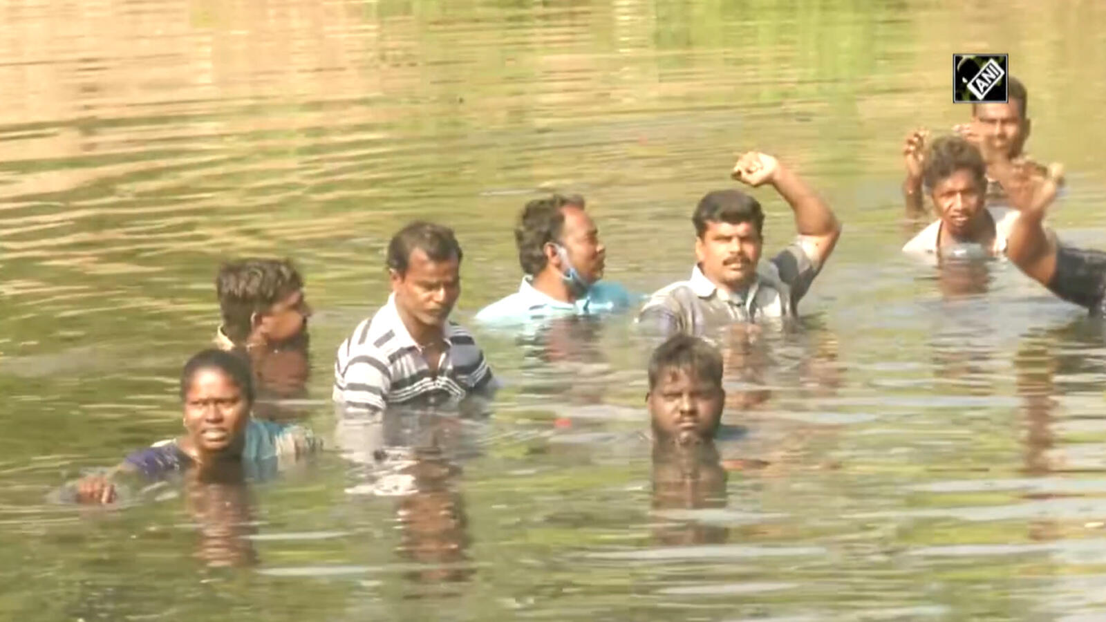 Chennai slum dwellers stand neck-deep in river to protest eviction
