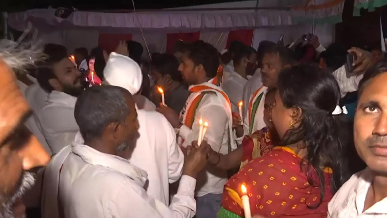 Congress workers carry out candle march protest outside PAC Guest House ...
