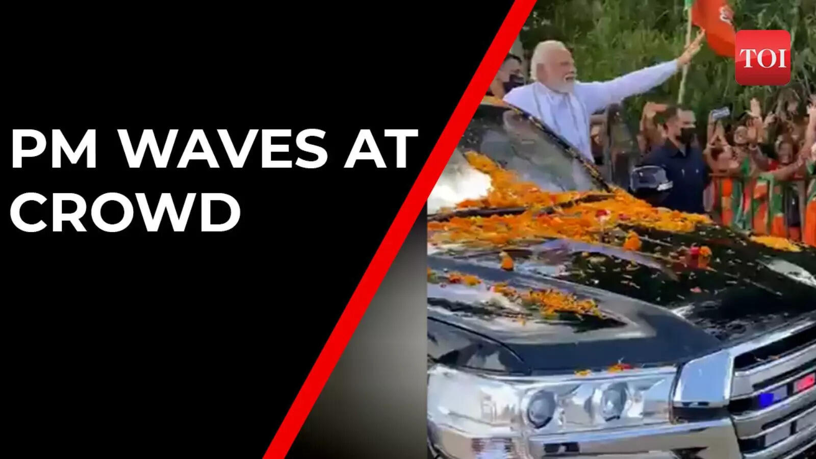 Prime Minister Narendra Modi greets the crowd during his roadshow in ...