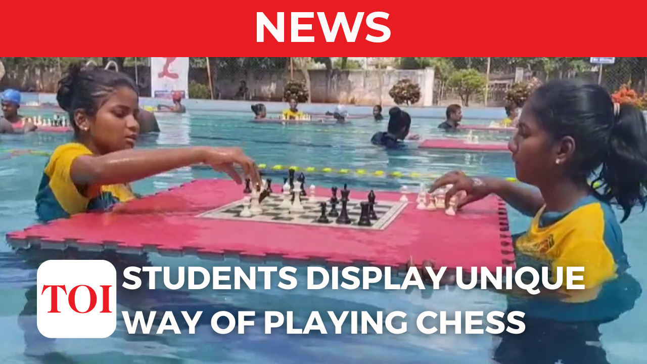 Students play chess in swimming pool