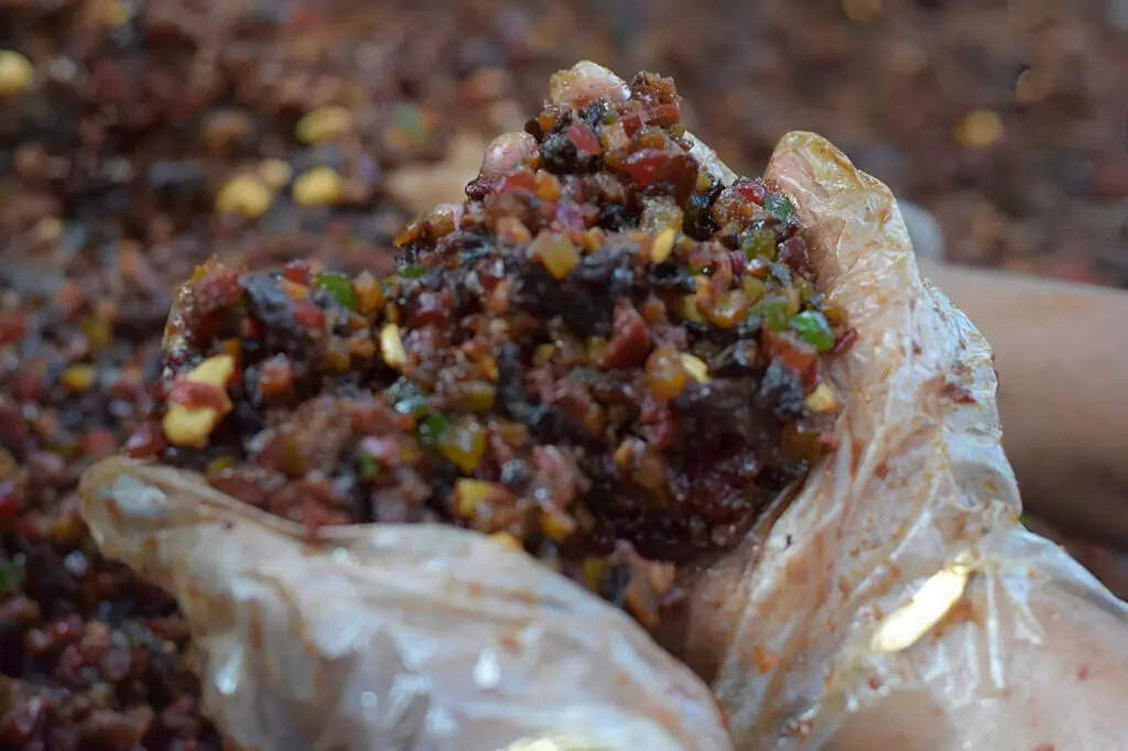 Locals get together for a unique Christmas fruit cake-mixing held at ...